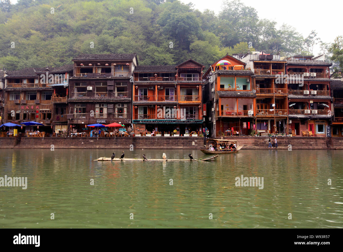 People visit the Fenghuang ancient town scenic area in during the week ...
