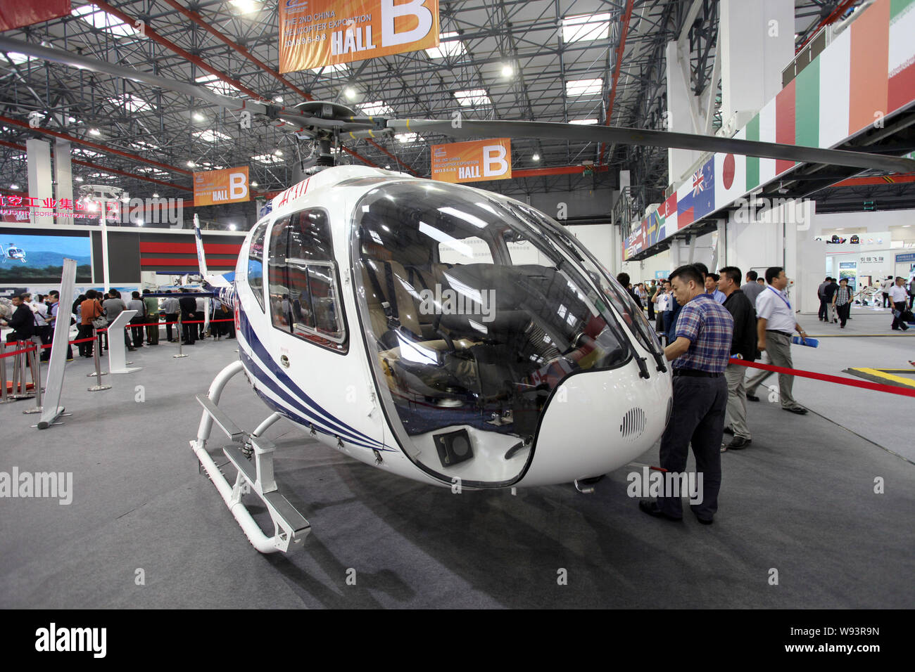 Visitors look at an AC311 civilian light helicopter of AVIC (Aviation ...