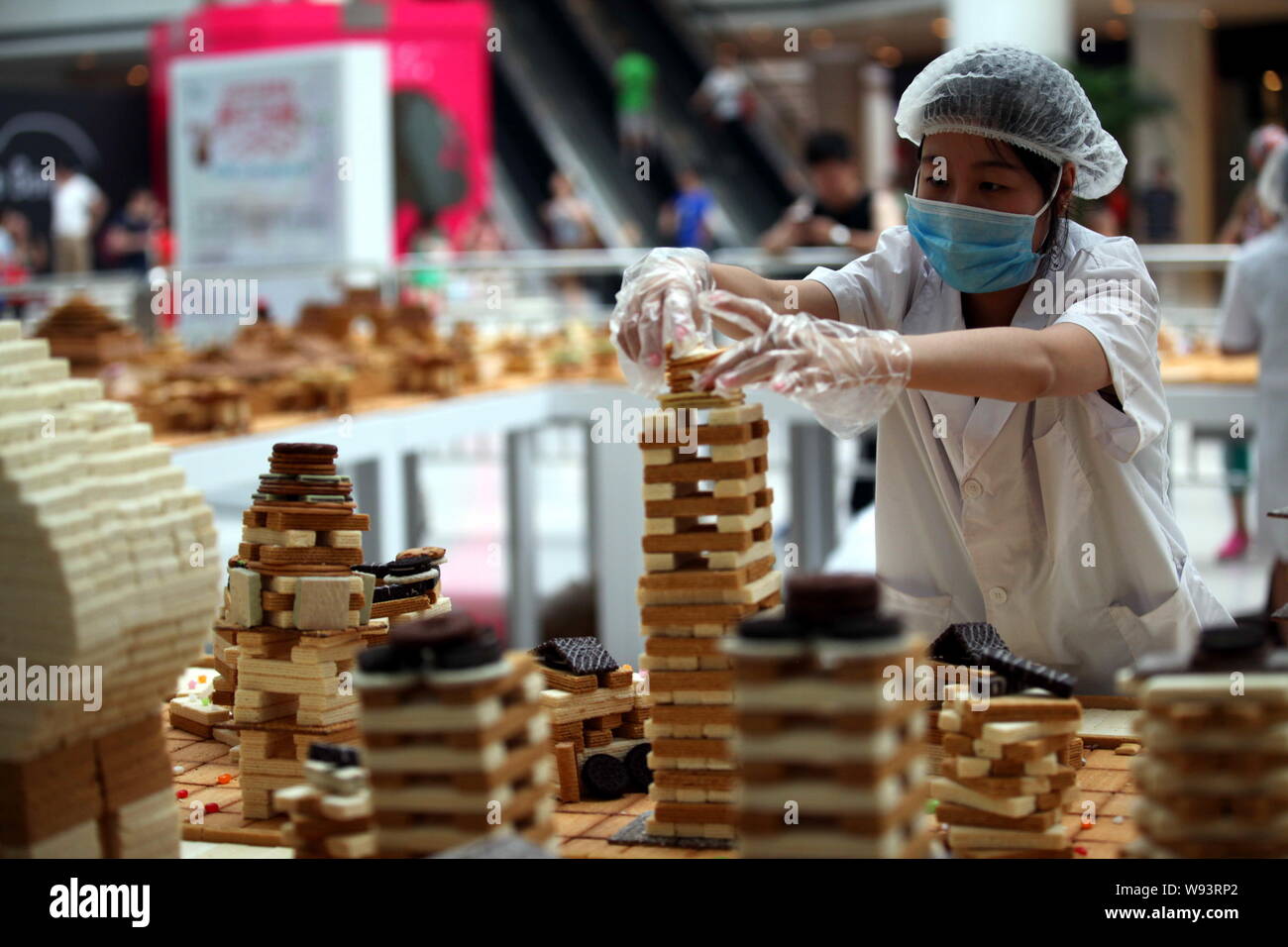 A Chinese student makes a miniature building with biscuits, wafers ...