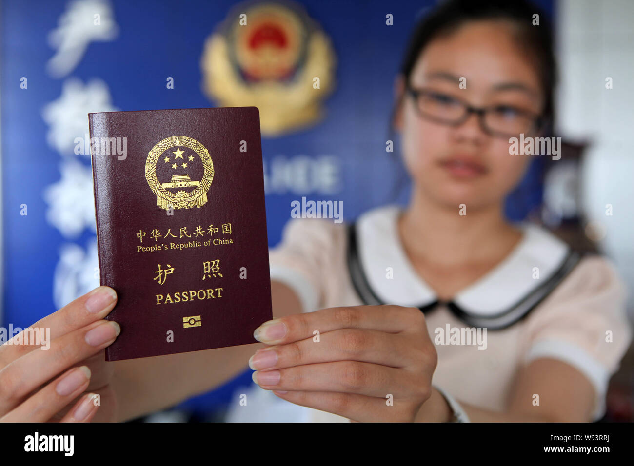 --FILE--A local resident shows her passport at the Exit-Entry ...