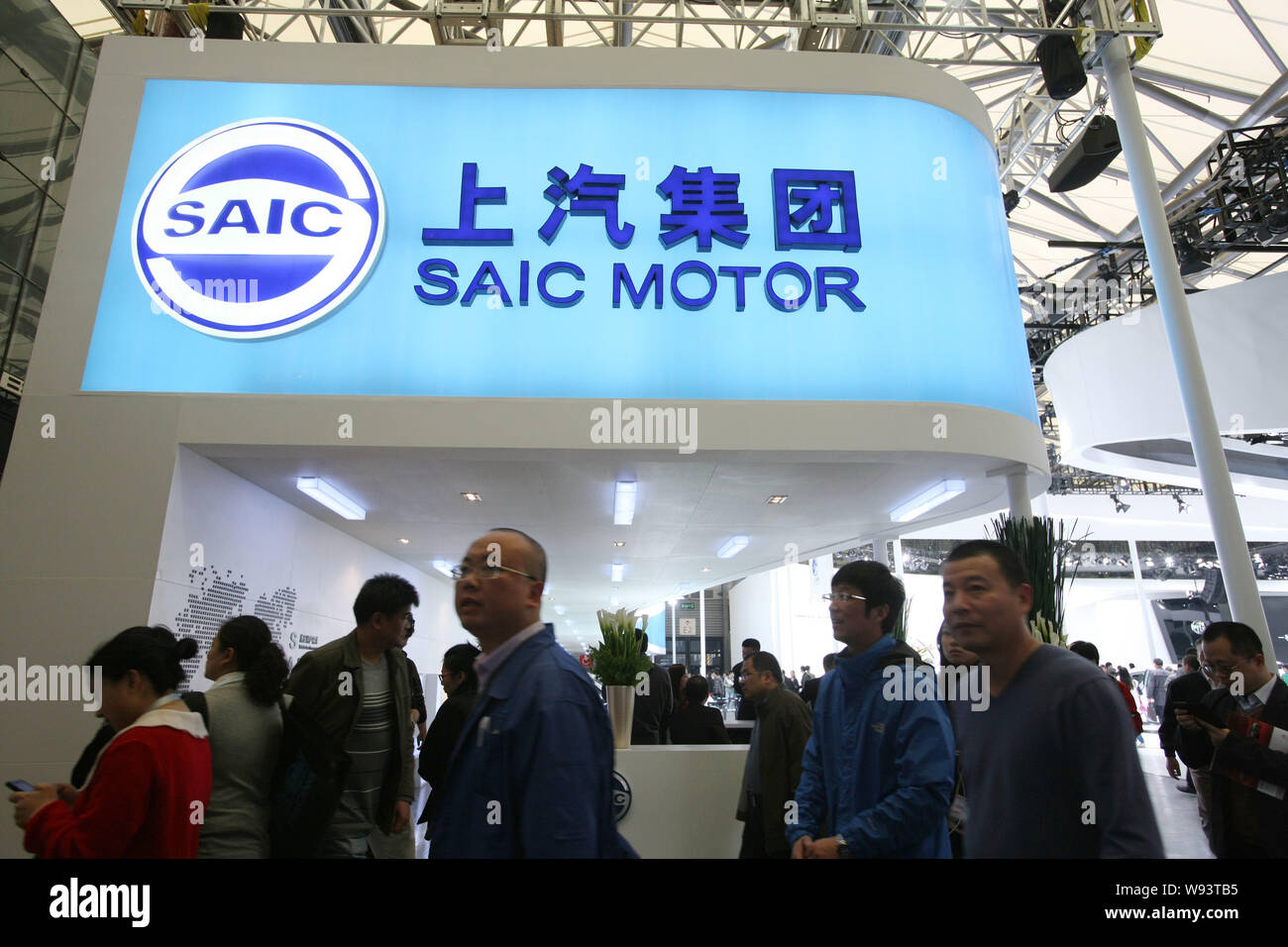 Visitors walk past the stand of SAIC Motor during the 15th Shanghai ...