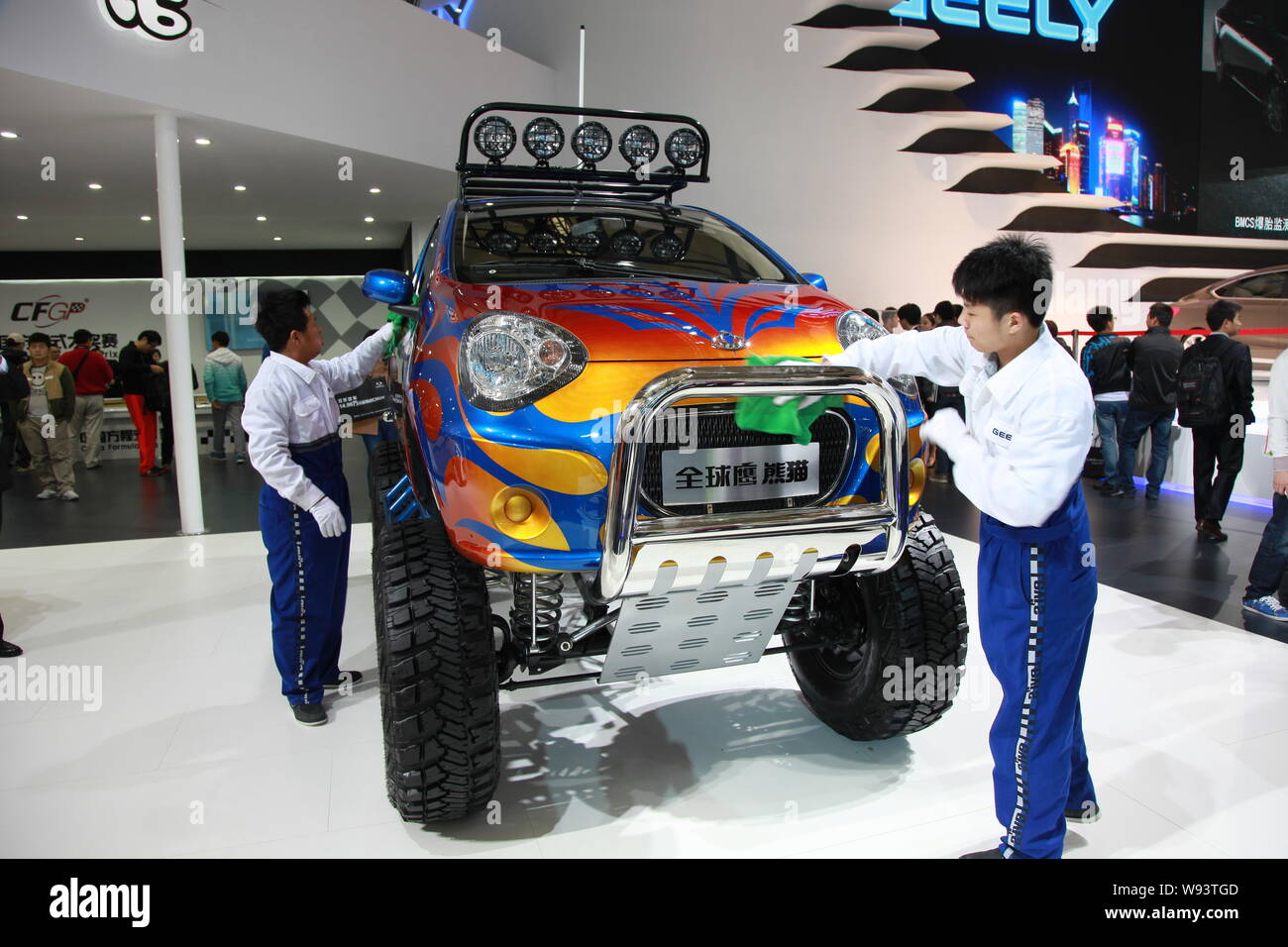 Workers dust off a refitted Geely Gleagle Panda during the 15th ...