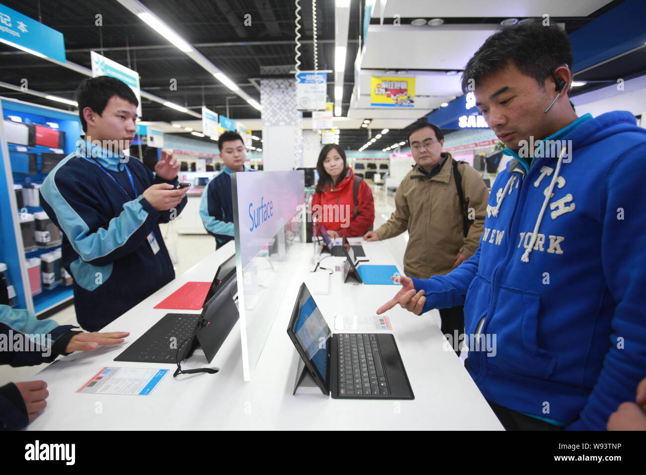 Chinese shoppers try out Microsoft Surface Pro tablet PCs at a home ...