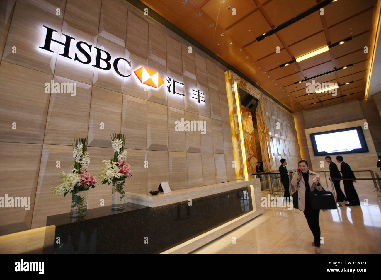 --FILE--A woman walks past the front desk at the China headquarters of ...