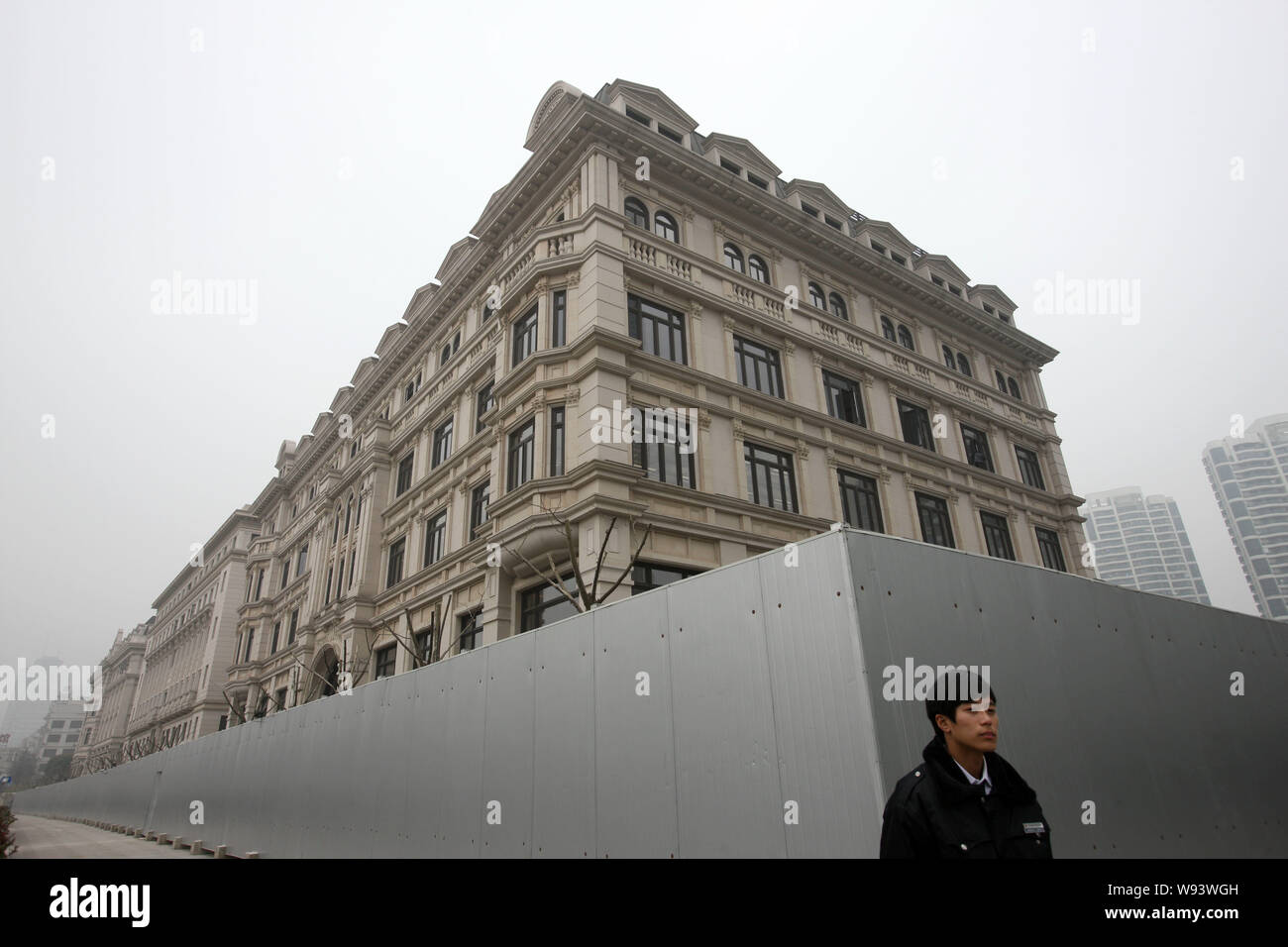 A Chinese security guard stands next to the three western-style ...