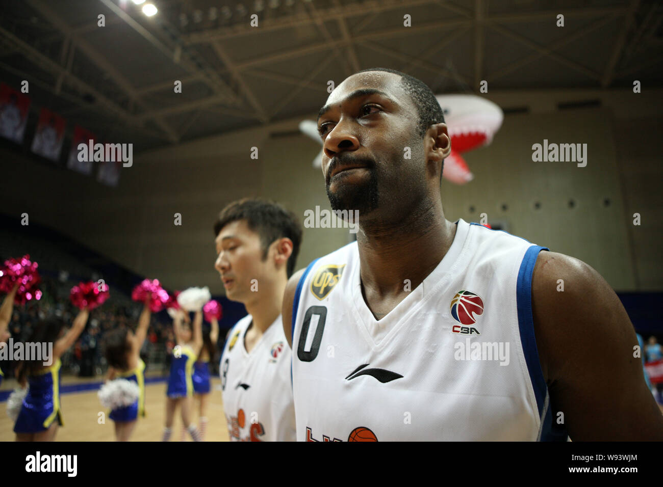 Gilbert Arenas of the Shanghai Sharks, front, looks on after he and his ...