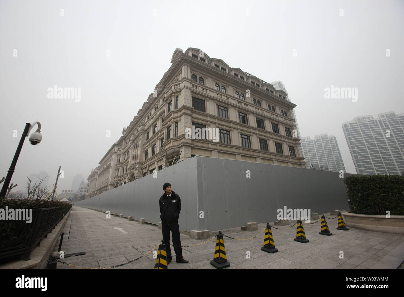 A Chinese security guard stands next to the three western-style ...