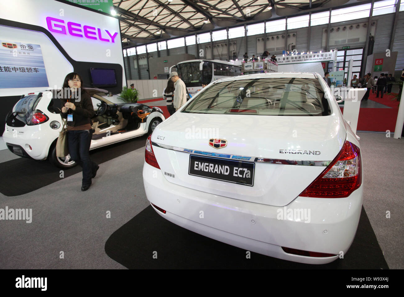 --FILE--Visitors look on at the stand of Geely during the 14th China ...