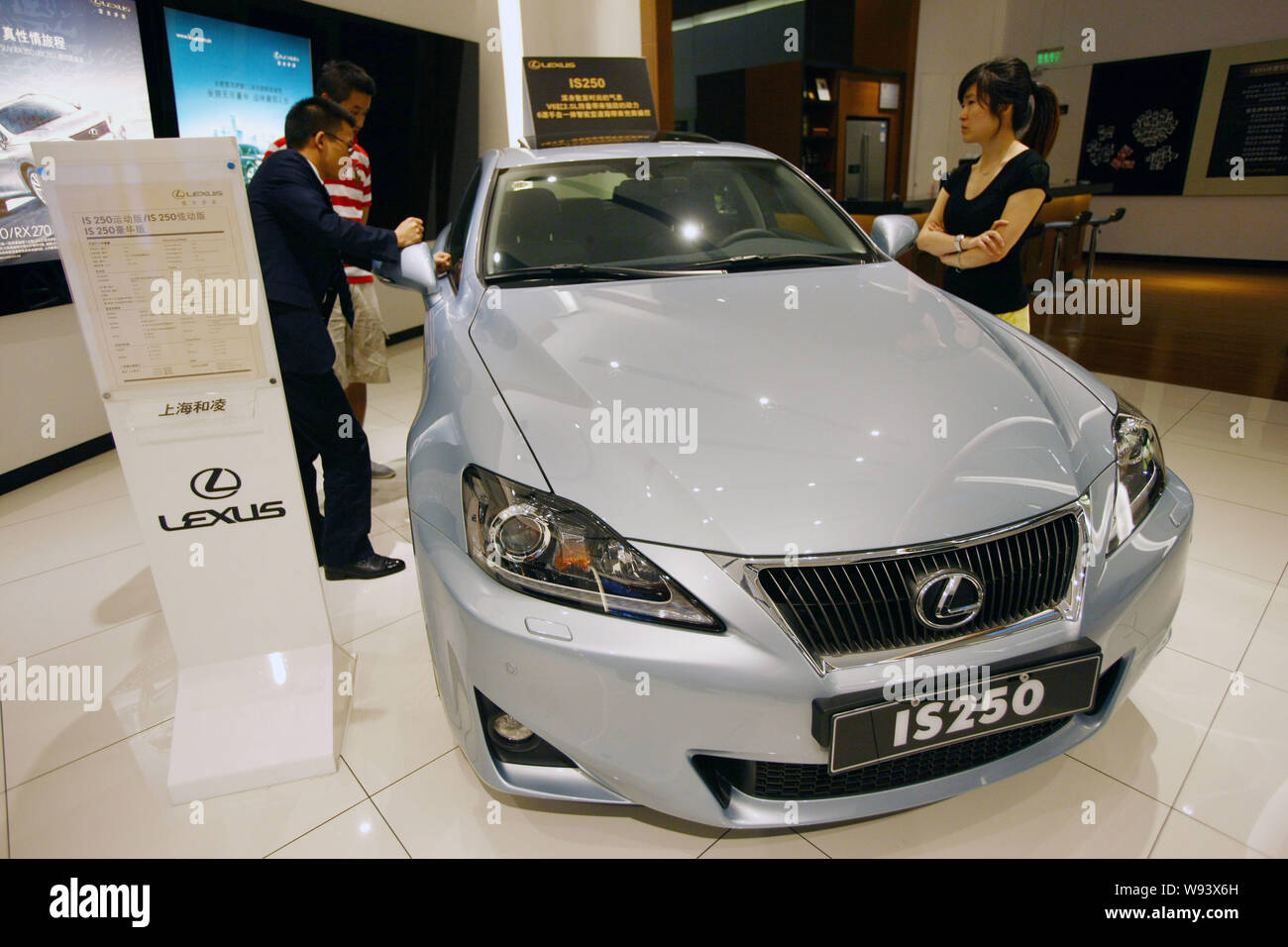 --FILE--Car buyers look at a Lexus IS 250 at a Lexus dealership in ...