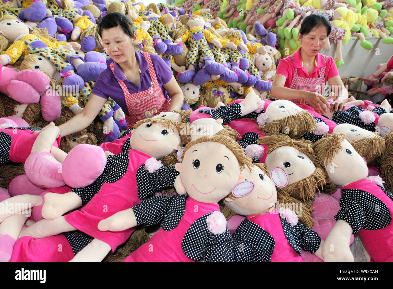 --FILE--Female Chinese workers check newly-made dolls to be exported to ...