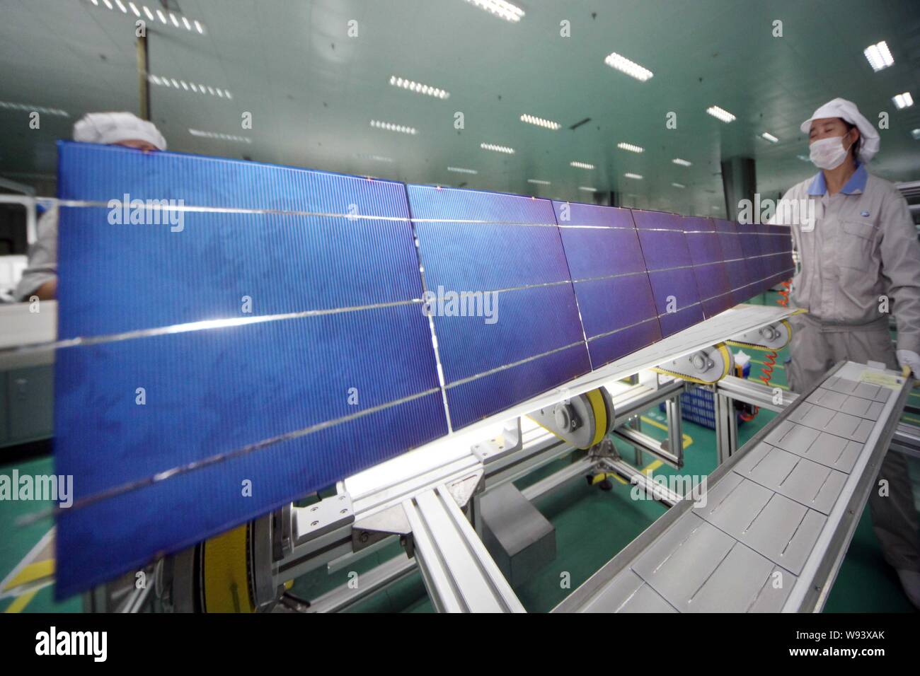 --FILE--Female Chinese workers manufacture PV (photovoltaic) cells to ...