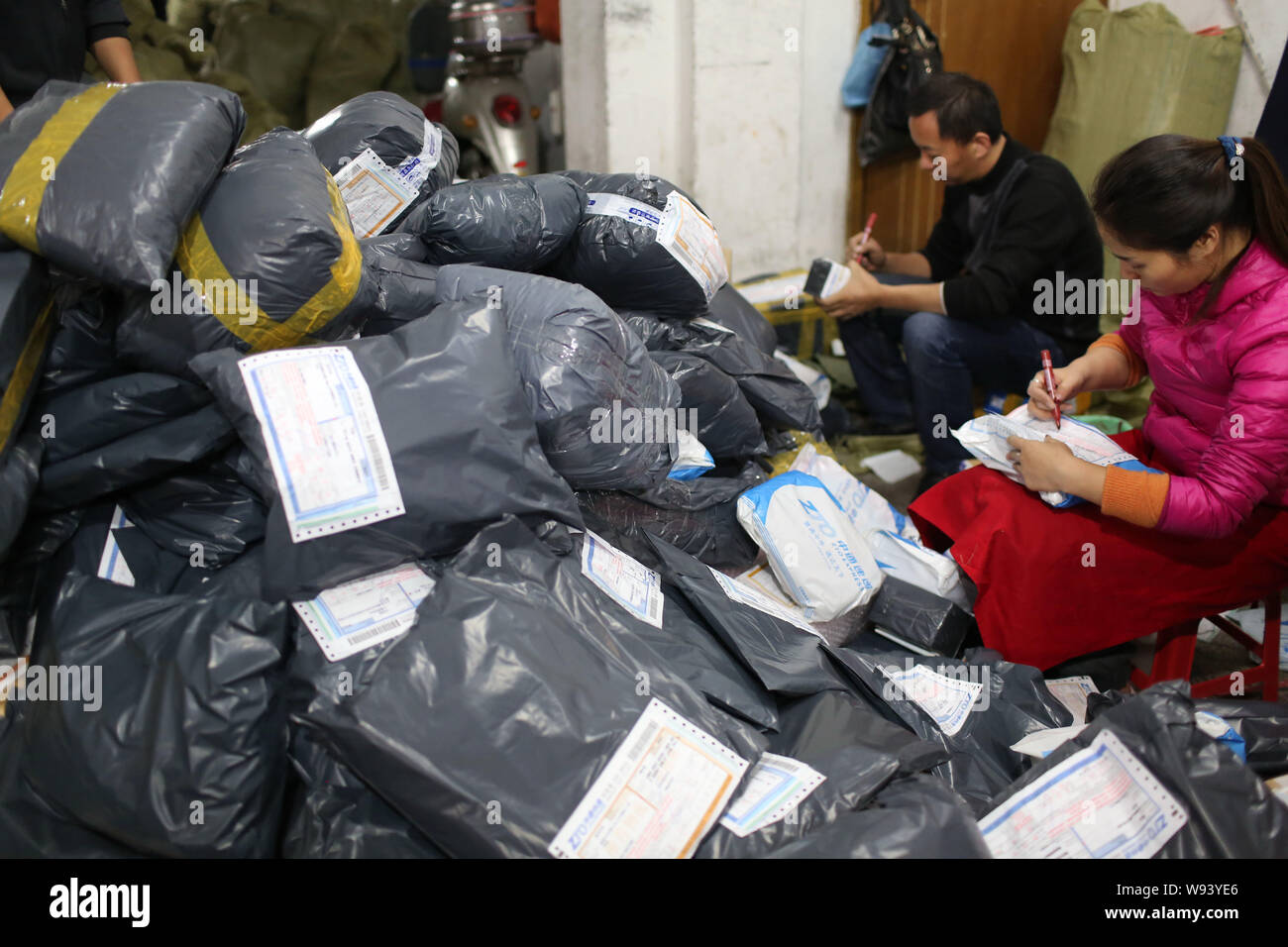 Chinese workers sort parcels, most of which come from online shopping ...
