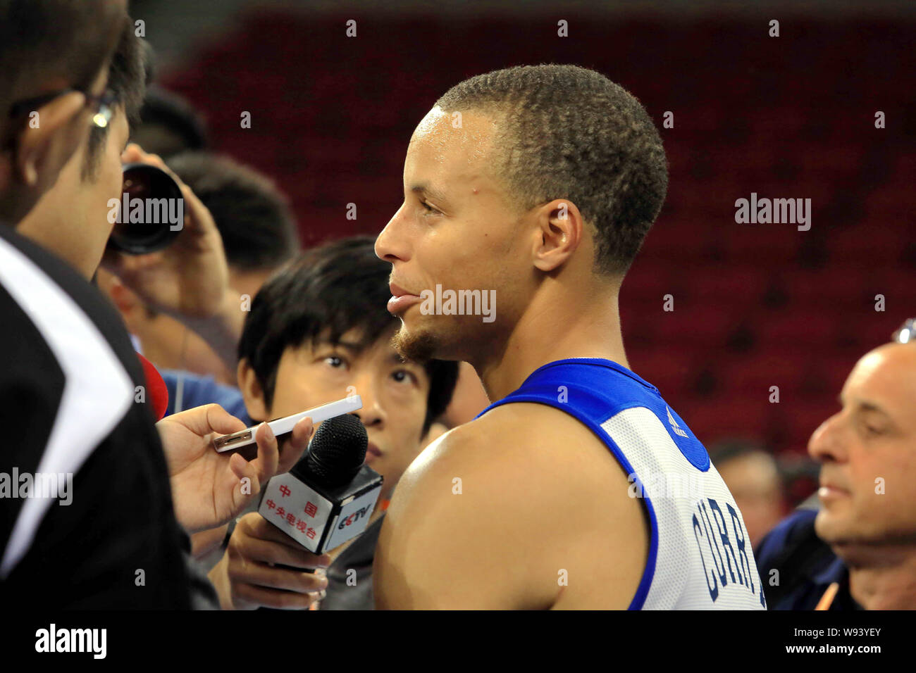 Stephen Curry of Golden State Warriors, center, is interviewed at a ...