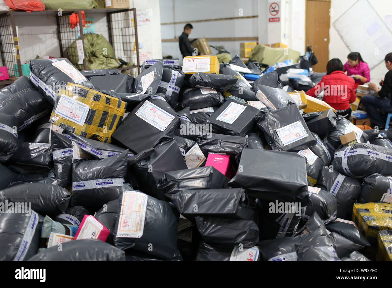 Chinese workers sort parcels, most of which come from online shopping ...