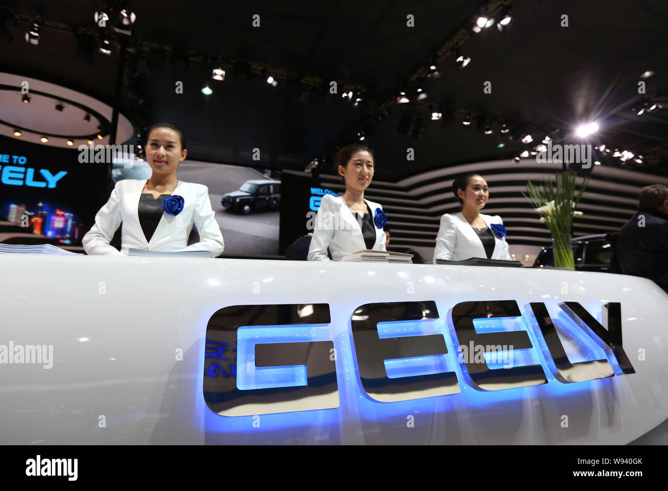 Young Chinese women pose at the stand of Geely during the 15th Shanghai ...