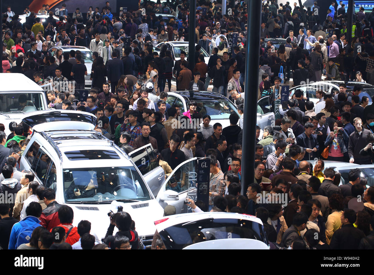 Visitors crowd around Mercedes-Benz cars during the 15th Shanghai ...