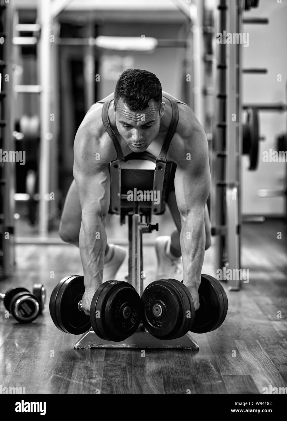 Man doing dumbbell row workout for back muscles Stock Photo - Alamy