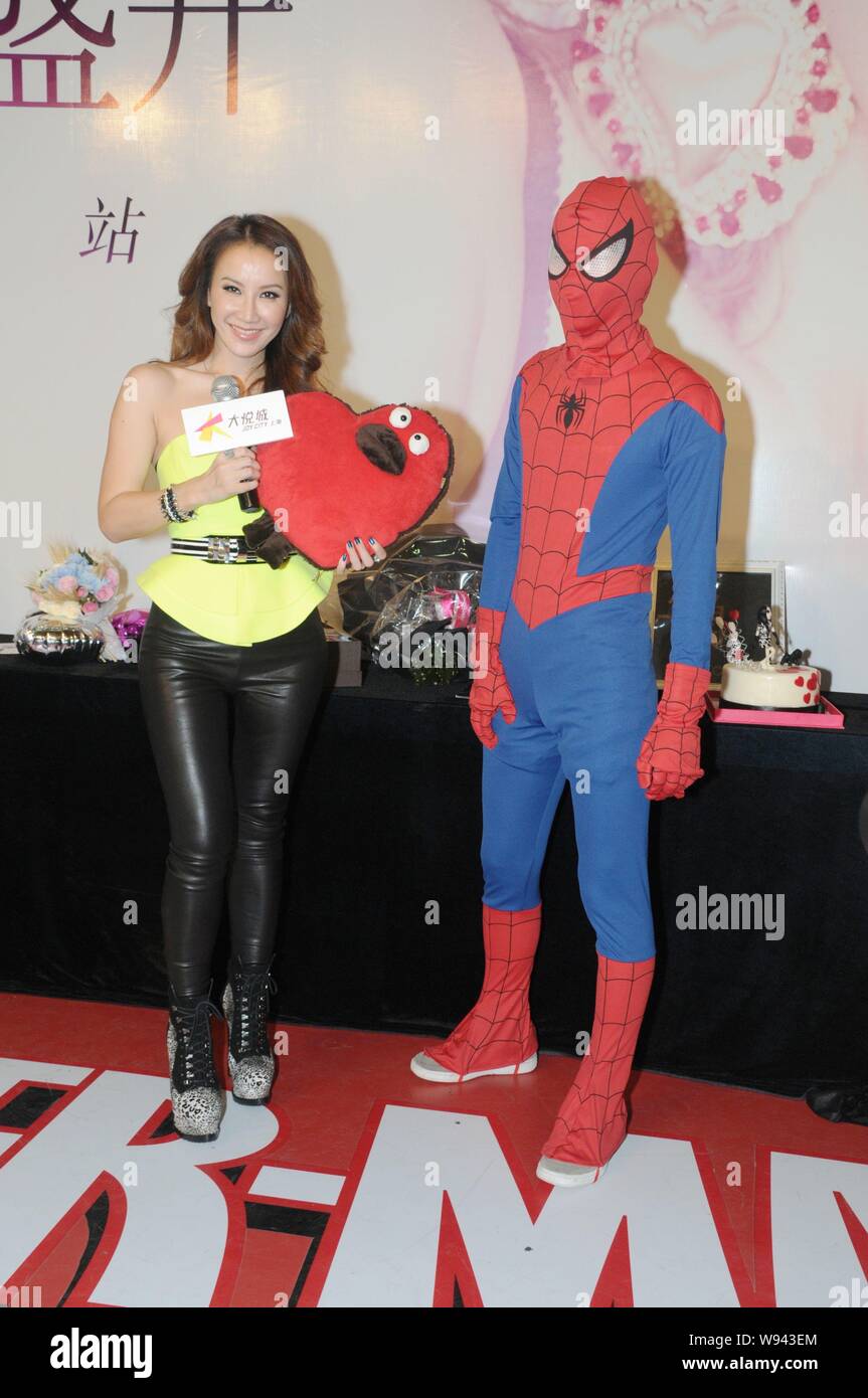 U.S. singer Coco Lee smiles next to Spiderman during a fan meeting in ...