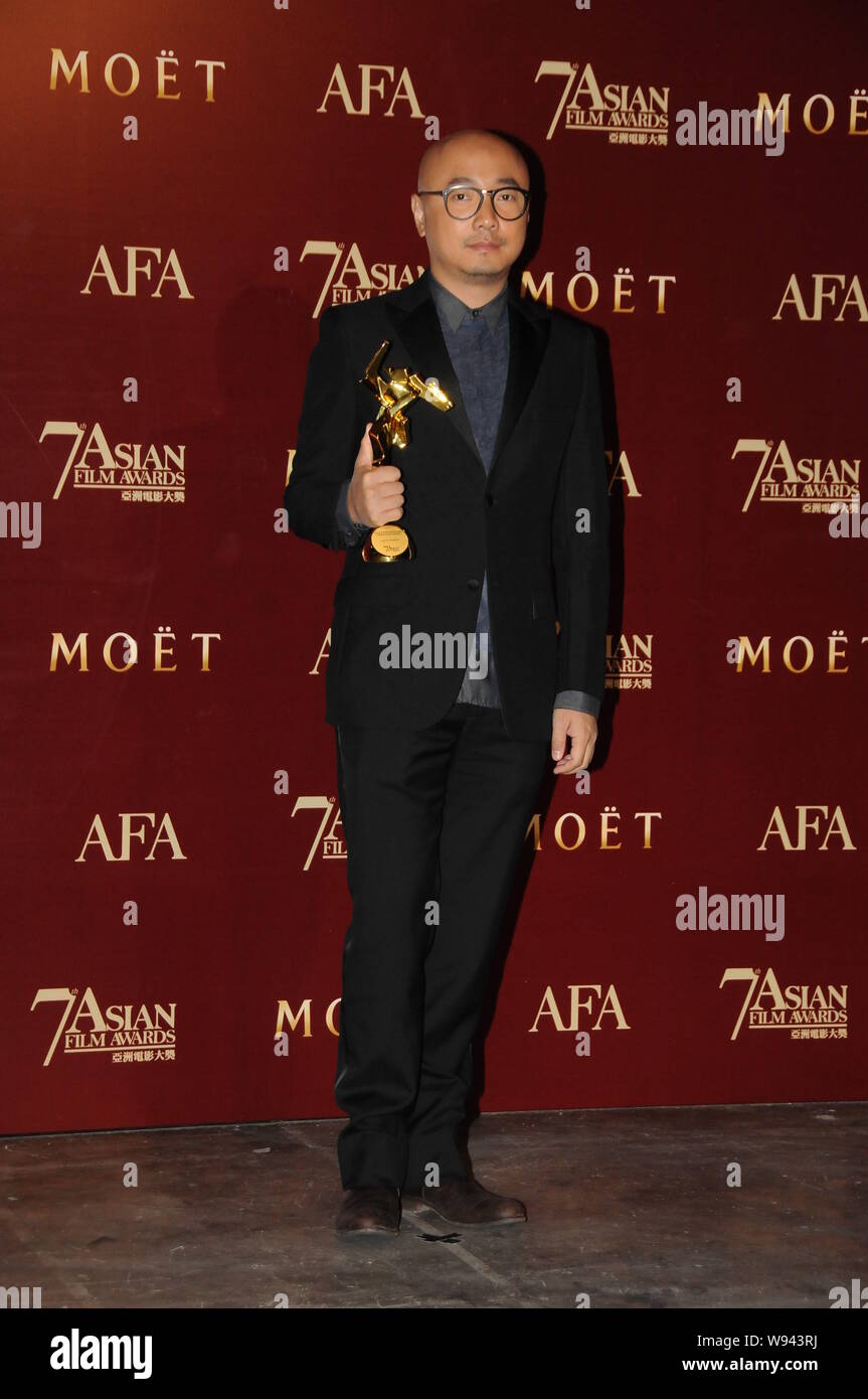 Chinese actor and director Xu Zheng poses with his trophy after winning ...