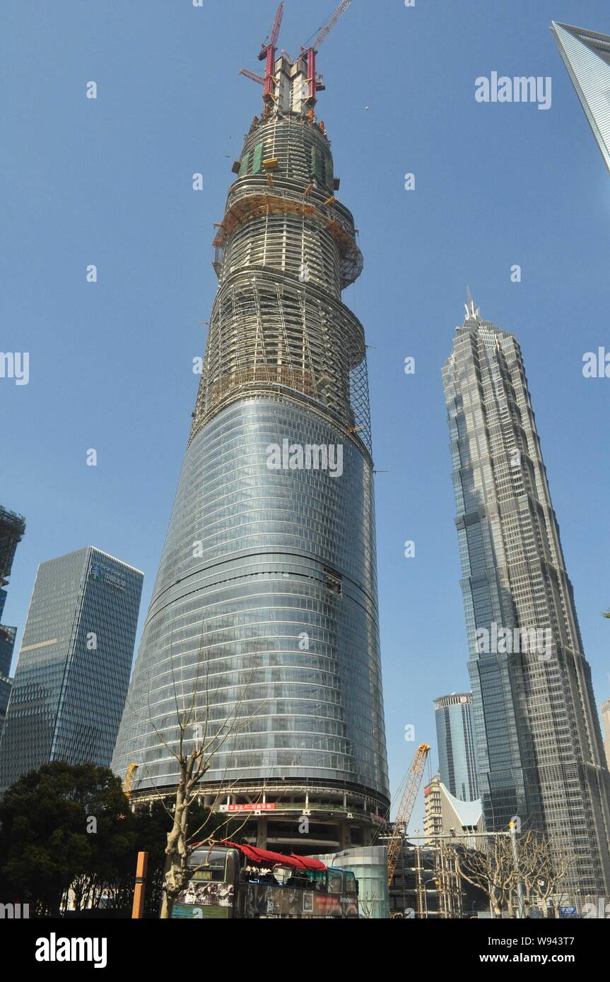 --FILE--The Shanghai Tower, center, is under construction next to ...