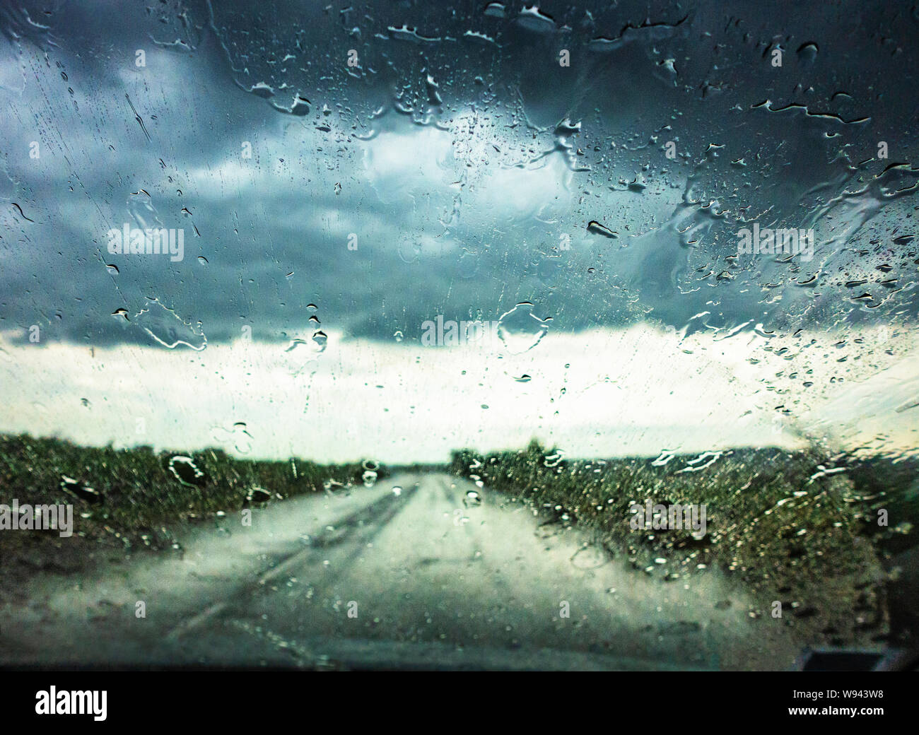 drivers view of heavy rain through car window Stock Photo - Alamy