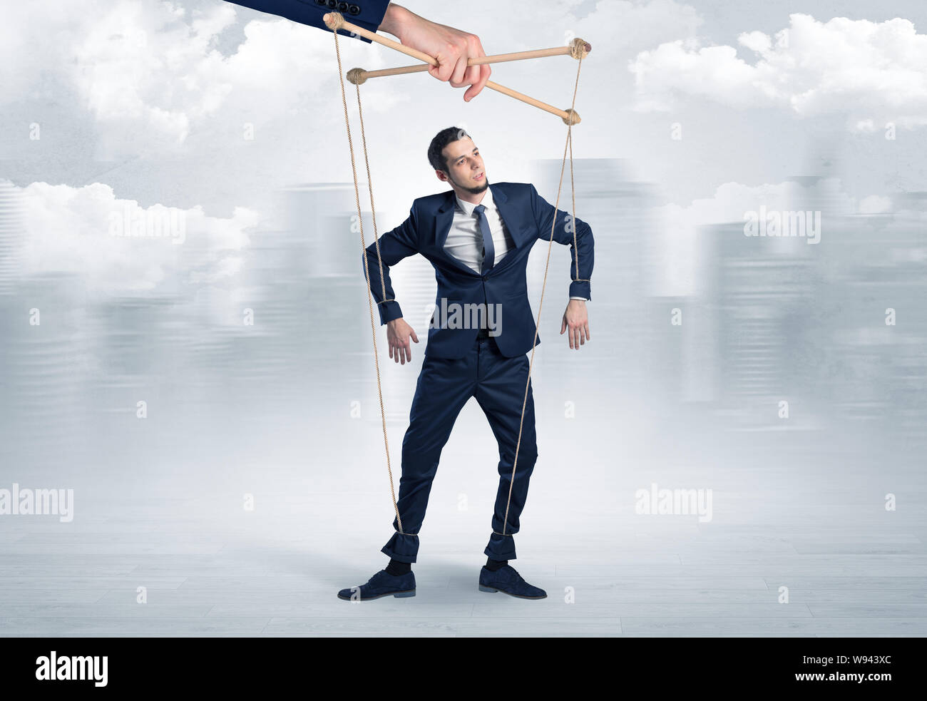 Puppet man with big city great power concept Stock Photo - Alamy