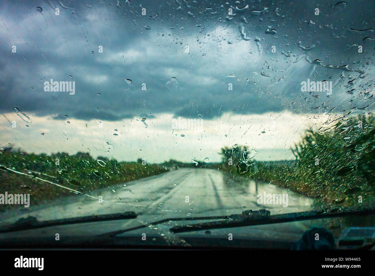 drivers view of heavy rain through car window Stock Photo - Alamy