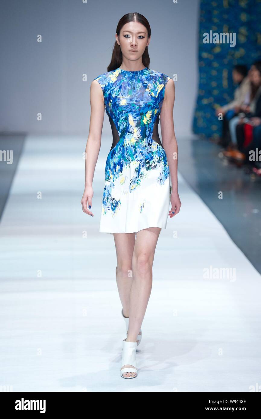 A model displays a new creation by designer Wang Peiyi, at the Wang ...