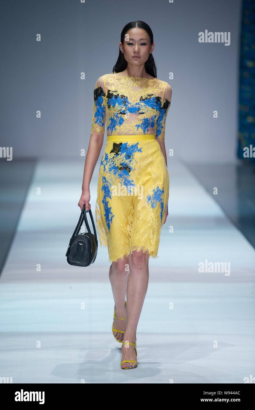 A model displays a new creation by designer Wang Peiyi, at the Wang Peiyi Spring/Summer 2014 ...