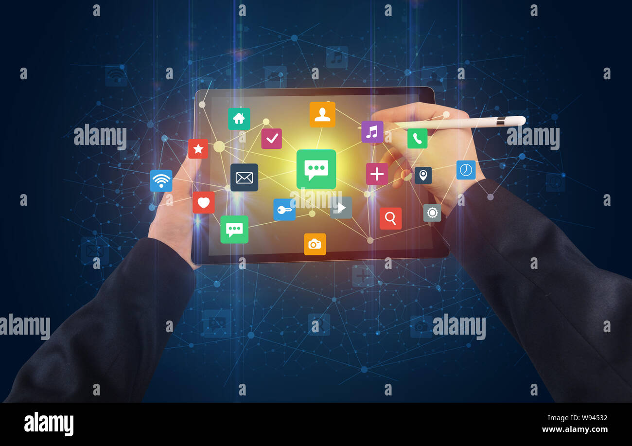 Hand using tablet with colorful bounce application symbols and icons ...