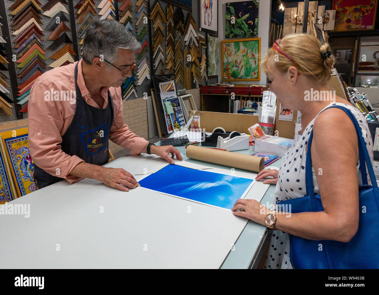 Lady picking picture frame hi-res stock photography and images - Alamy