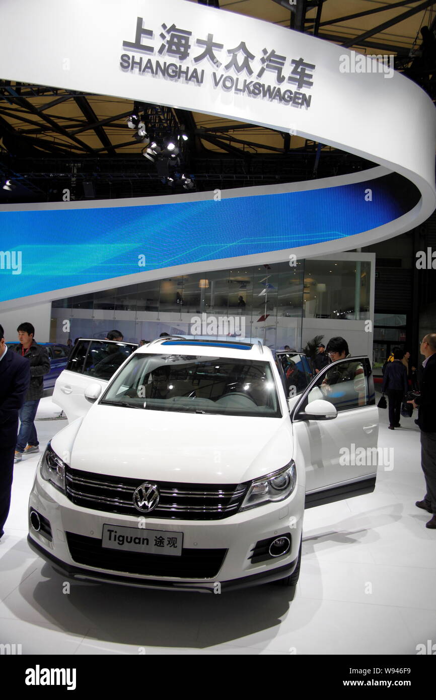 --FILE--Visitors try out a Tiguan SUV at the stand of Shanghai ...