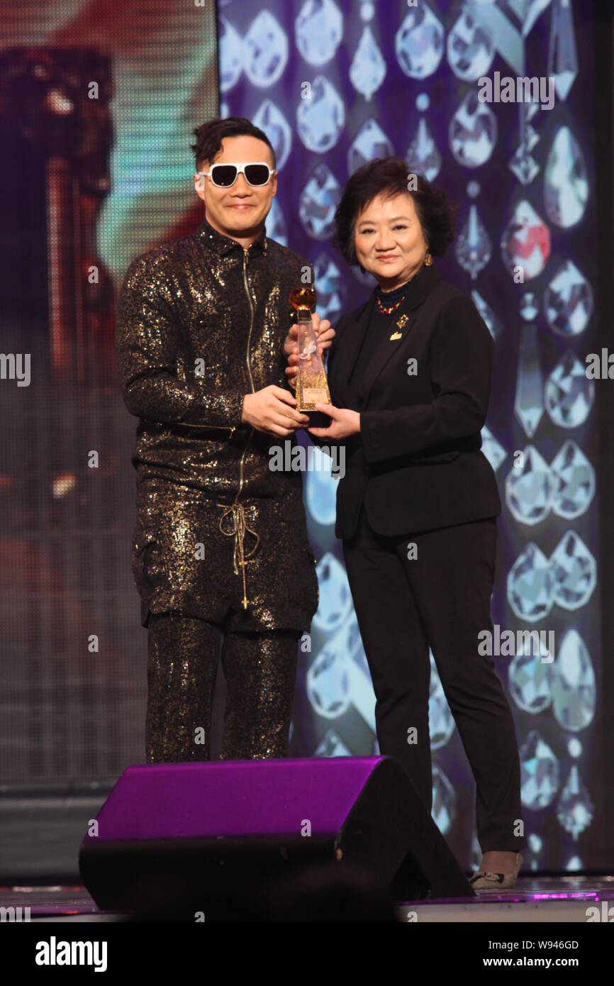 Hong Kong singer Eason Chan, left, shows his trophy of the Most Popular ...
