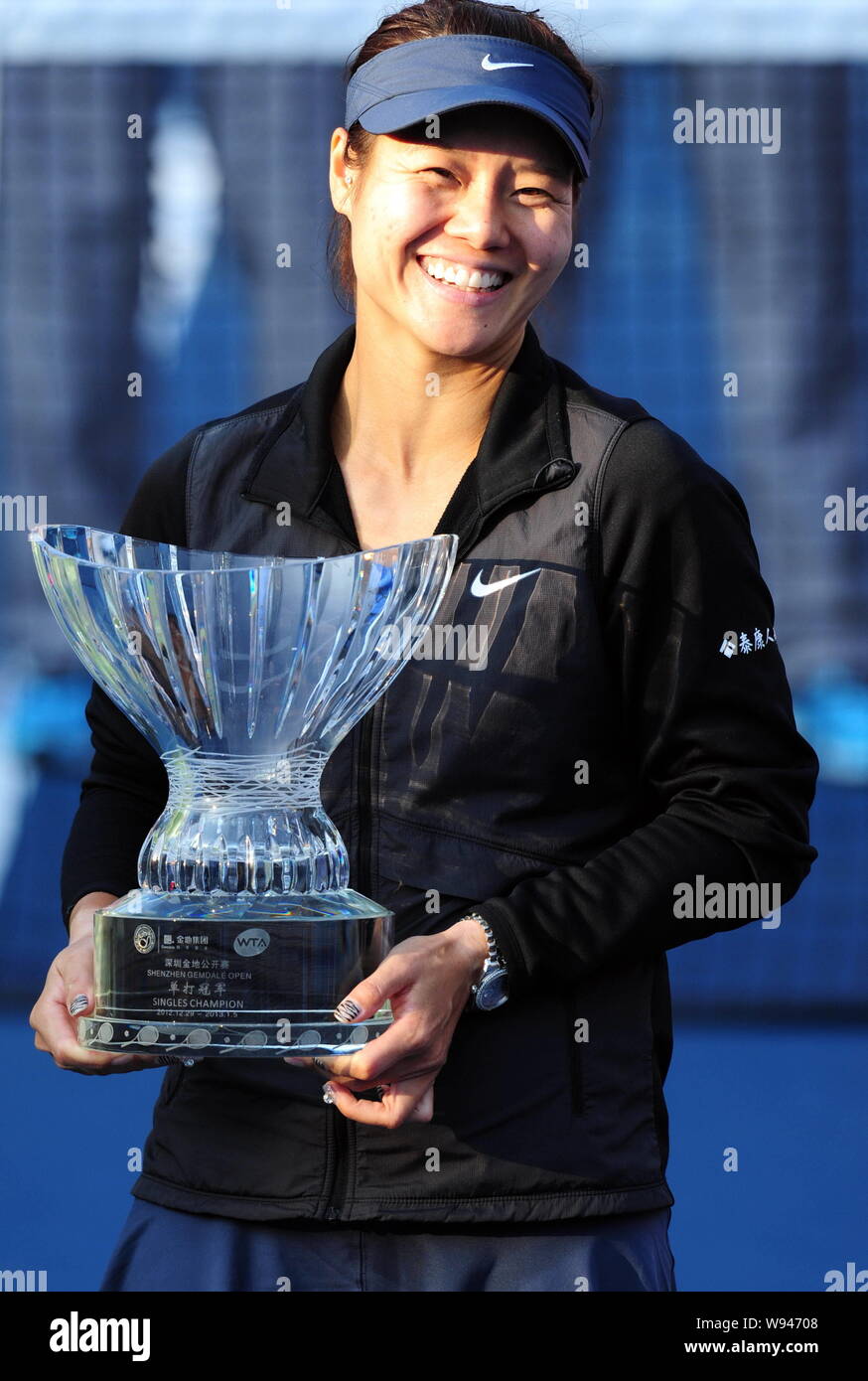 --FILE--Chinese tennis player Li Na shows her trophy after she won the ...