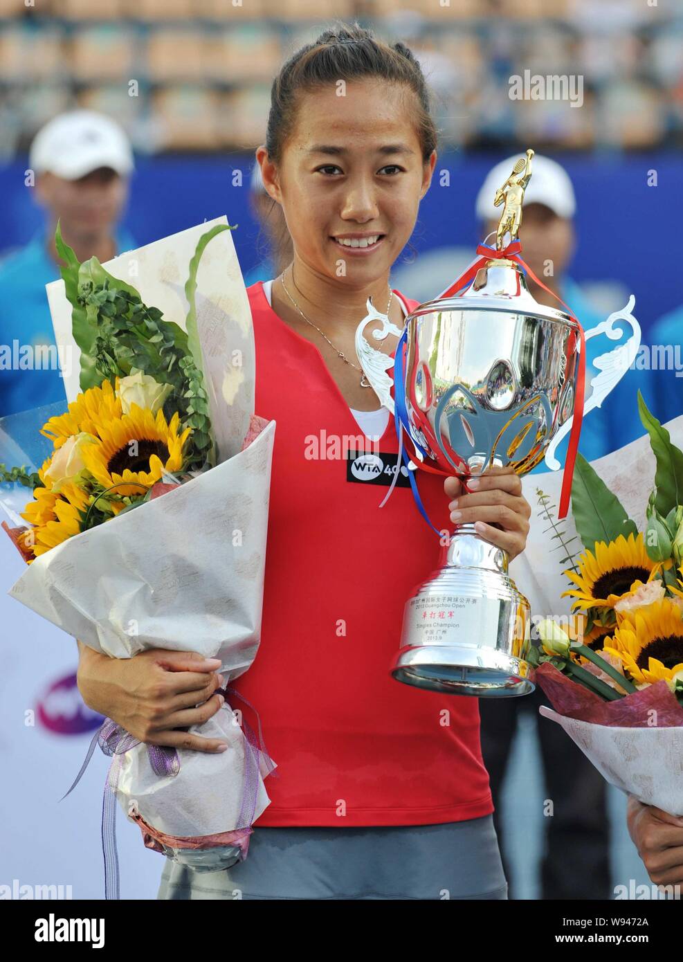Chinese professional tennis player Zhang Shuai displays her trophy and ...