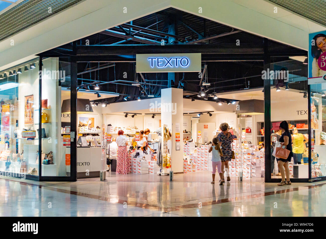 Customers walking and looking at shops in a French shopping Mall Stock ...