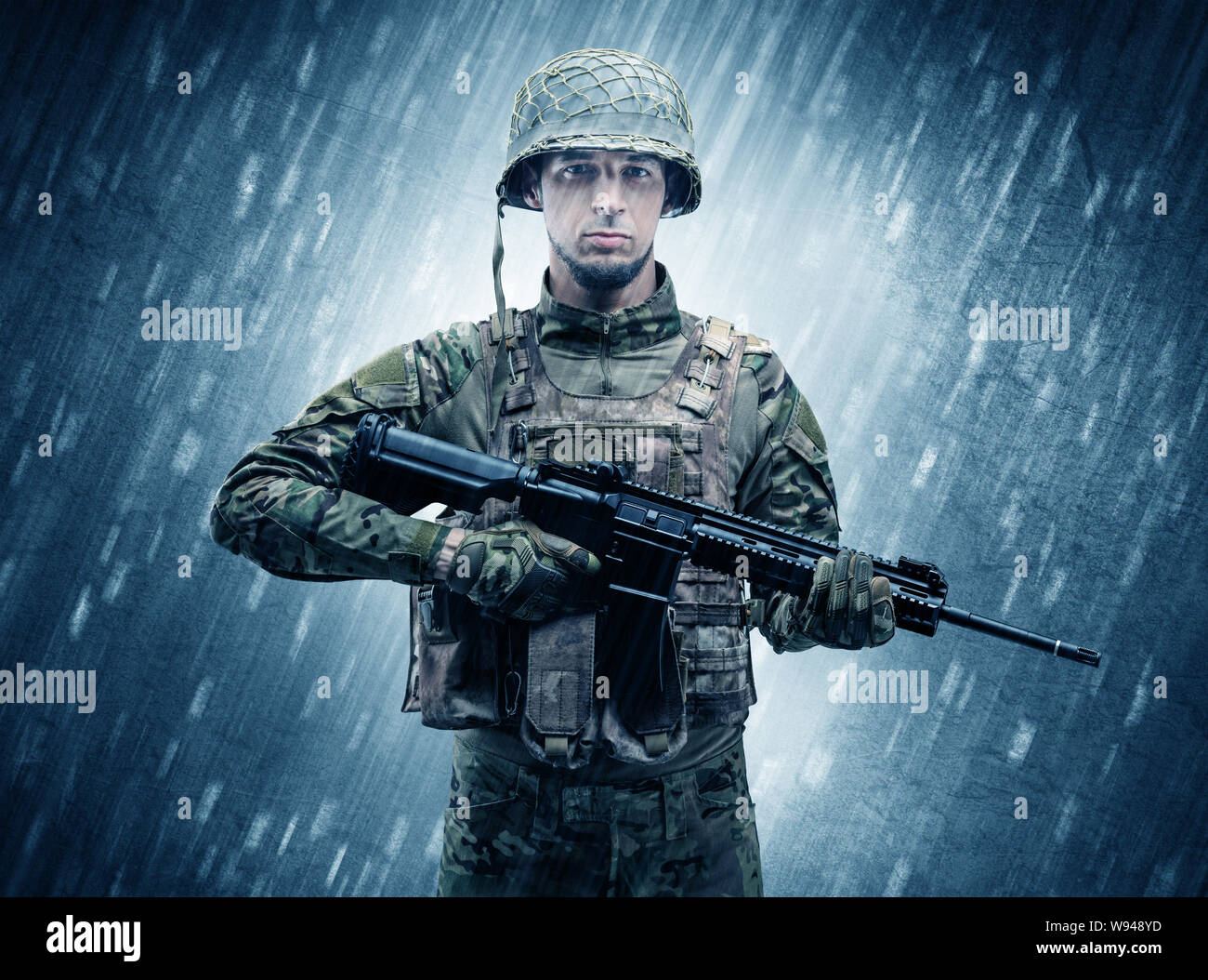 Armed soldier standing in rainy weather Stock Photo - Alamy