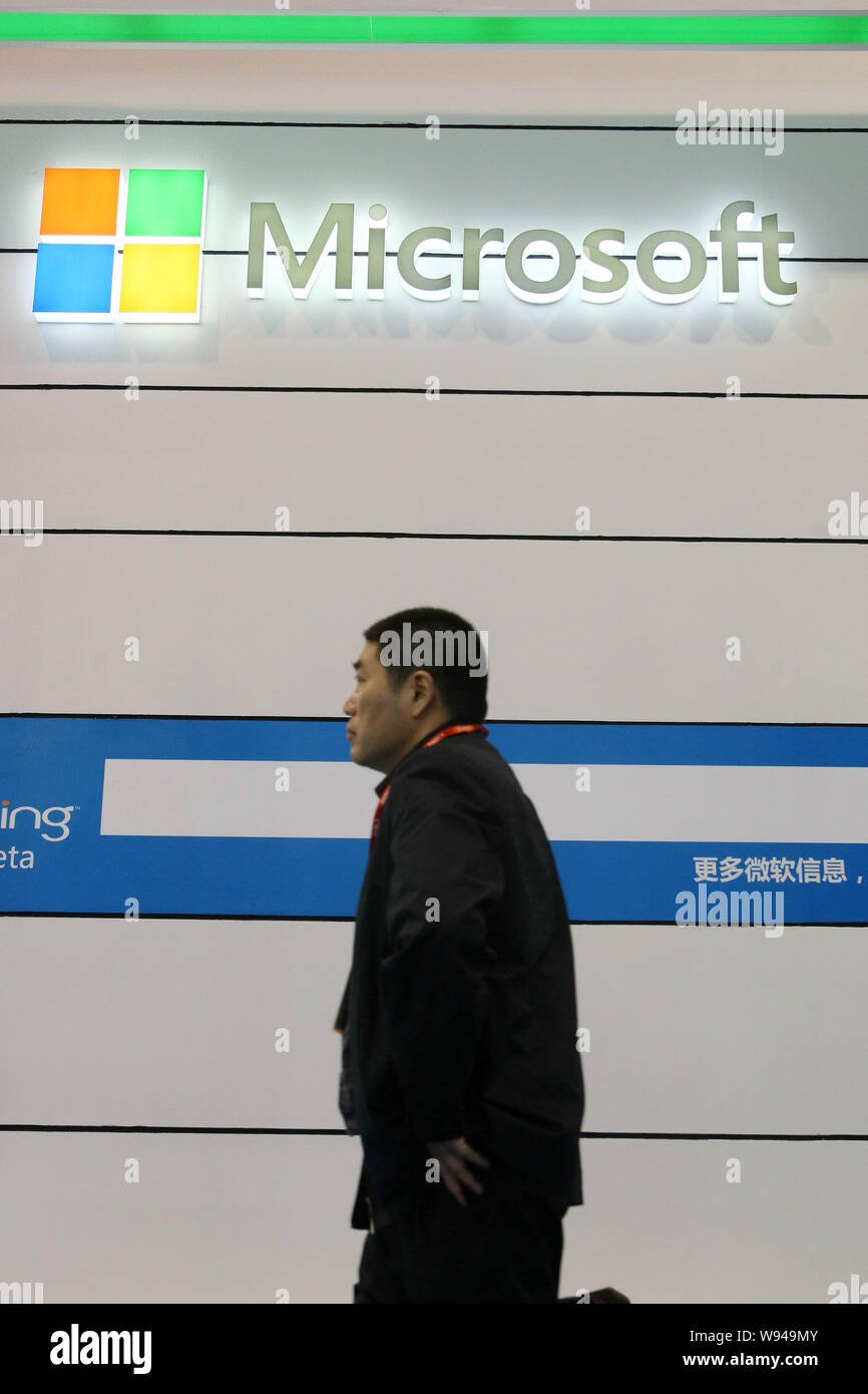 A visitor walks past the stand of Microsoft during the first China ...