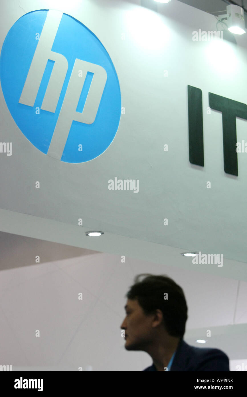 A visitor walks past the stand of HP during the first China (Shanghai ...
