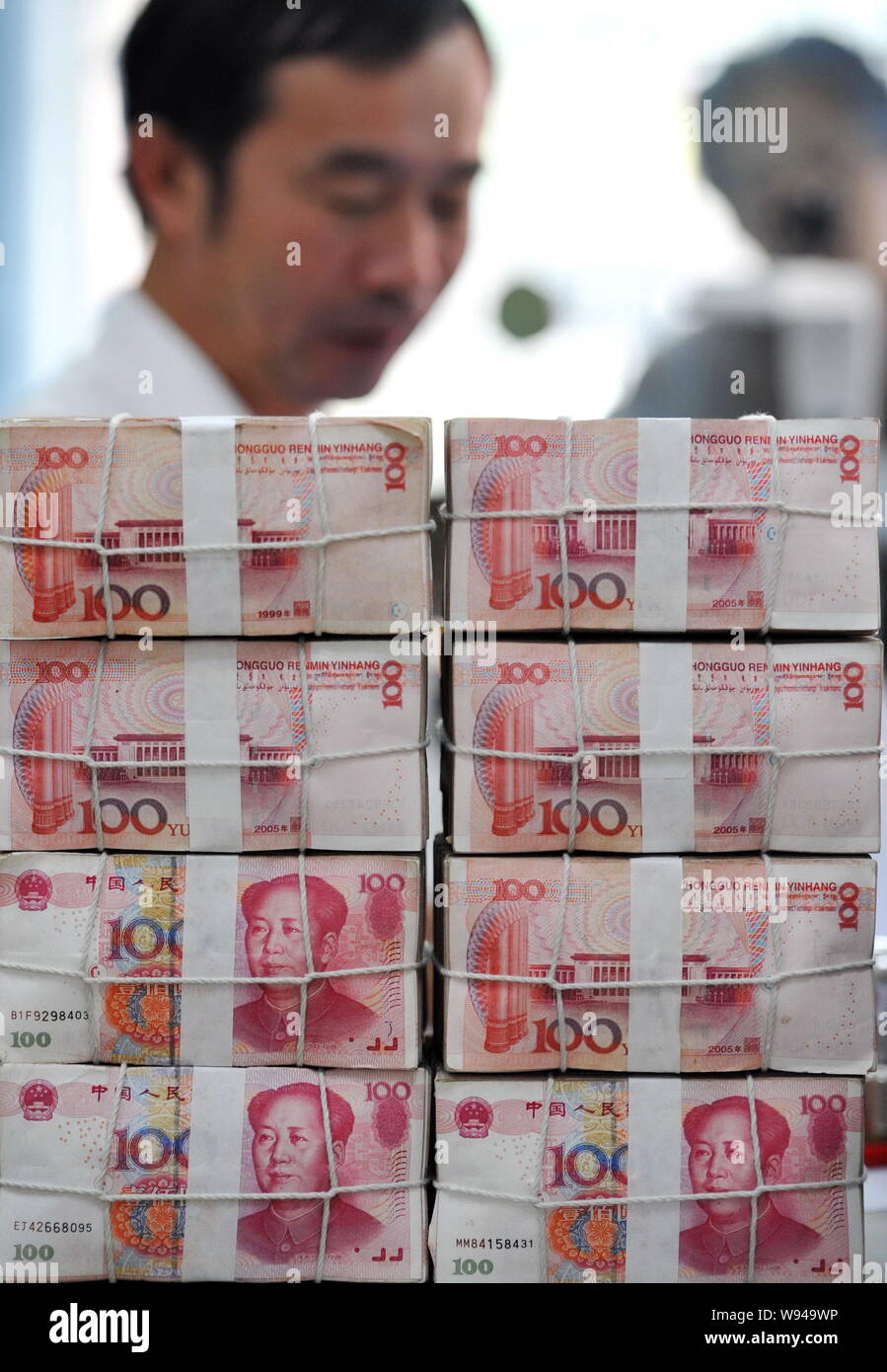 --FILE--Chinese clerks count RMB (renminbi) yuan banknotes at a branch ...