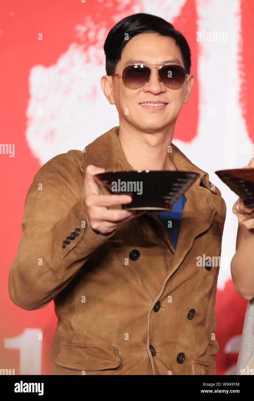 Hong Kong actor Nick Cheung proposes a toast during a press conference ...