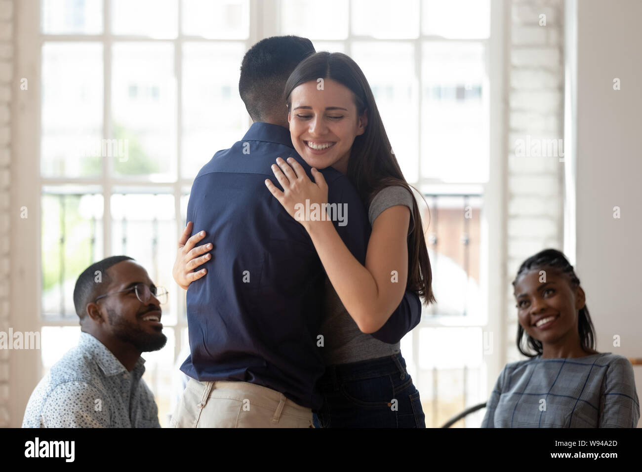 Relieved happy man and woman embrace give support during therapy Stock ...