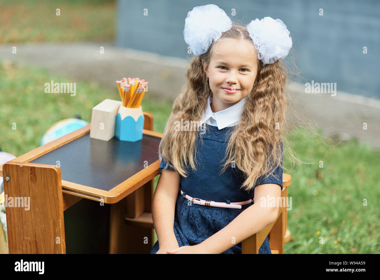 Portrait of beautiful young first-grader Farewell Bell. day of ...