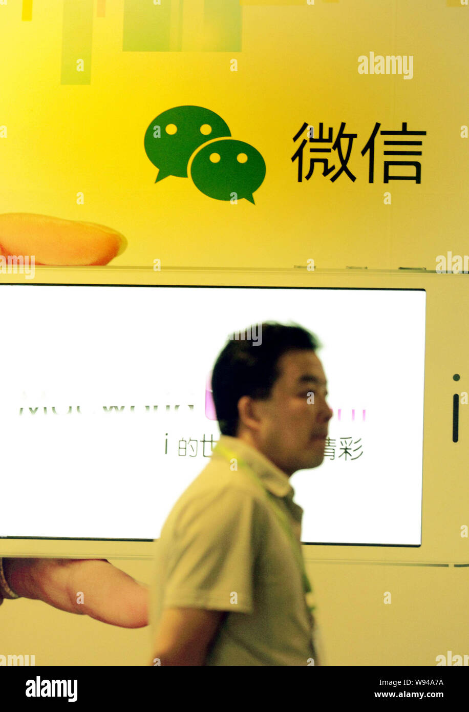 --FILE--A visitor walks past an advertisement for mobile messaging app ...