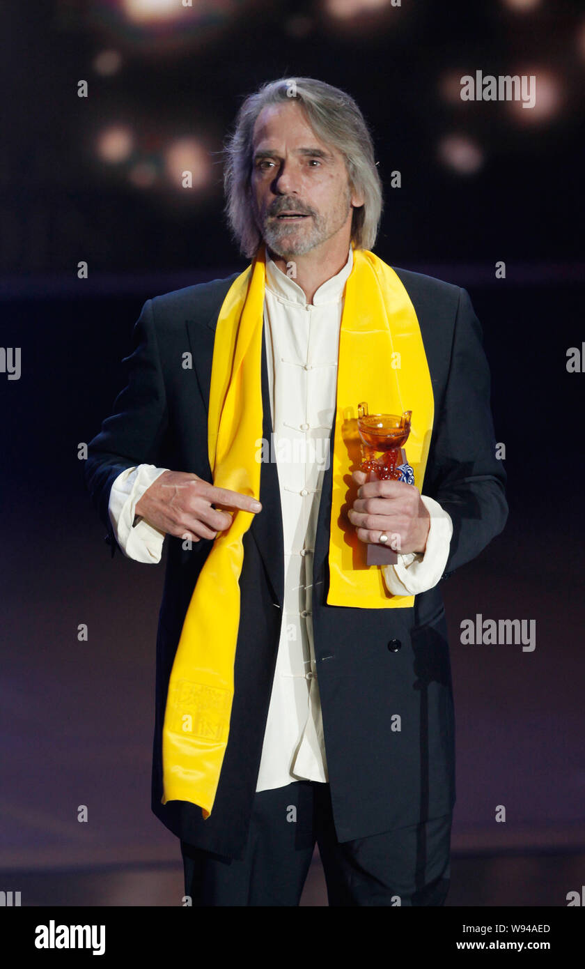English actor Jeremy Irons points at his trophy after he wins the ...