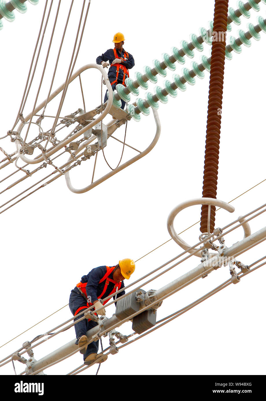 --FILE--Chinese electricians check high-voltage power lines in ...