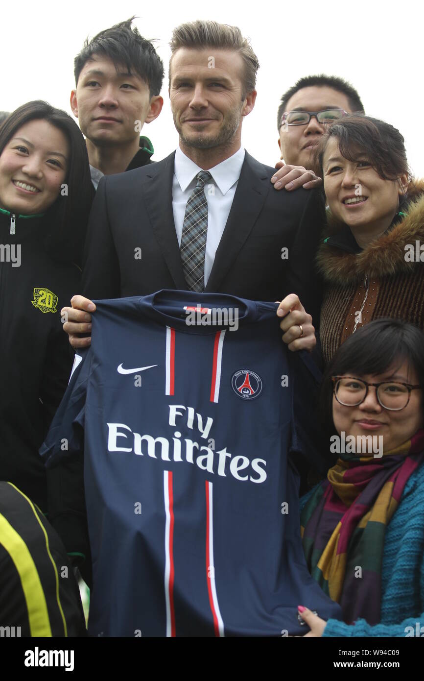 English soccer superstar David Beckham, center, poses with Chinese fans ...