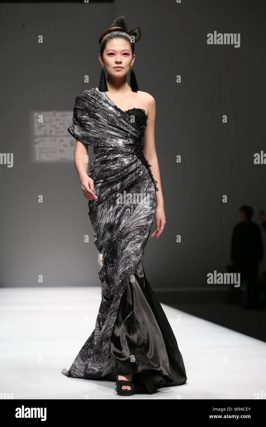 A model displays a new creation from Chinese designers of the Minzu University of China ...