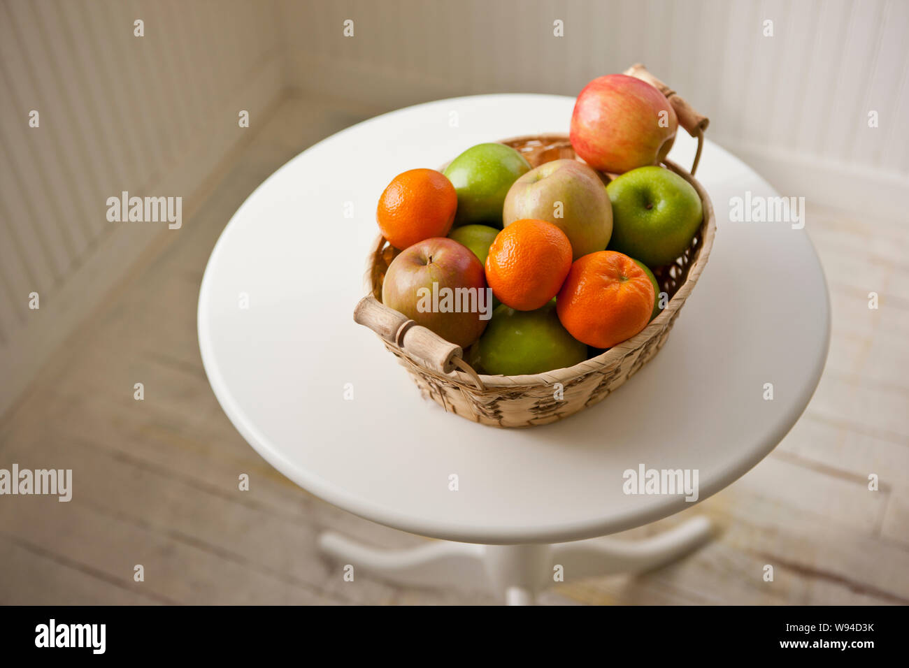 Basket of fresh fruit on a table inside a room Stock Photo - Alamy