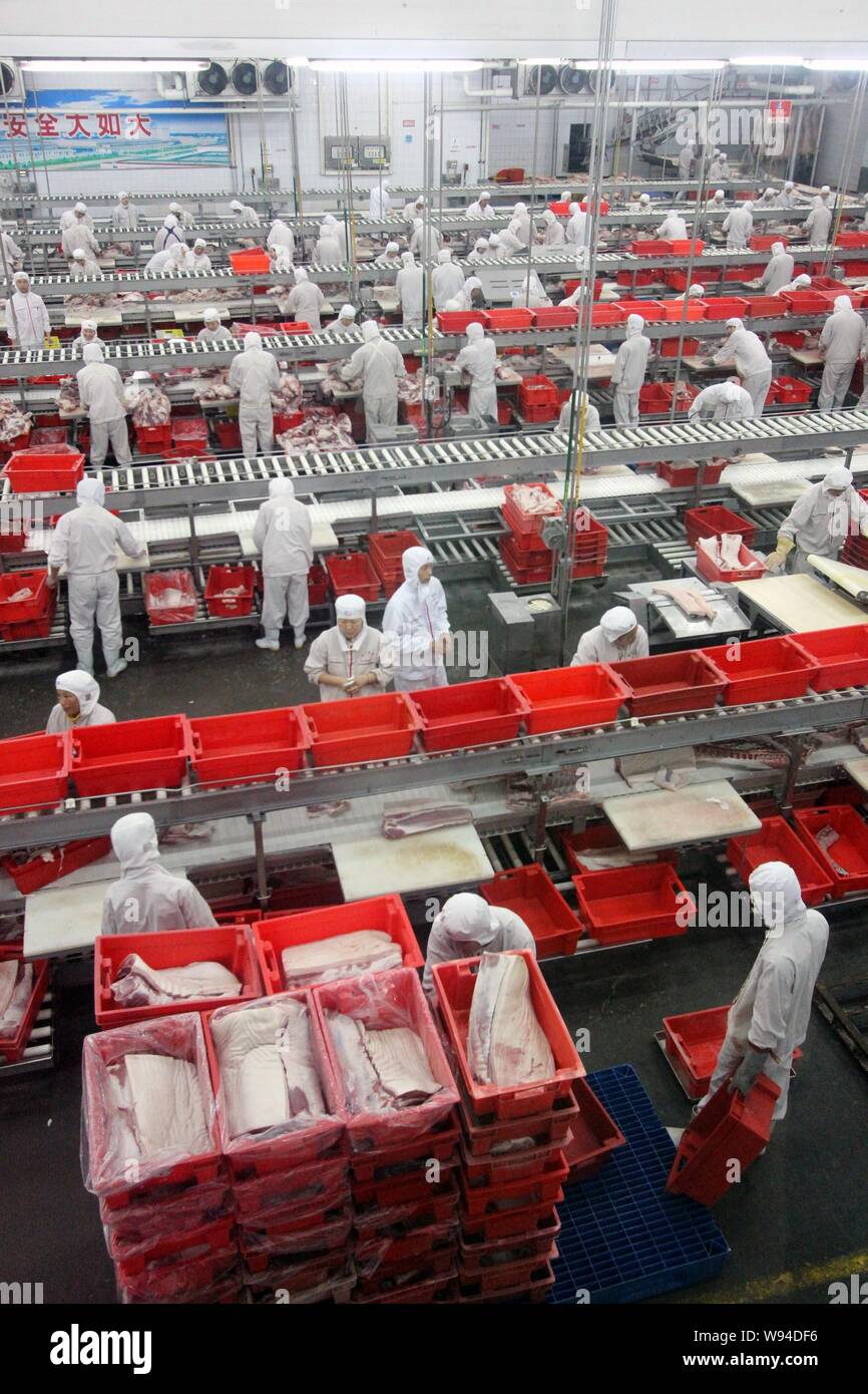 --FILE--Chinese workers cut up pork at the meat processing plant of ...
